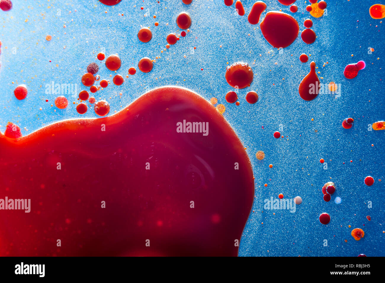 Red bubbles of blood cells on a blue background closeup. Abstraction of ...