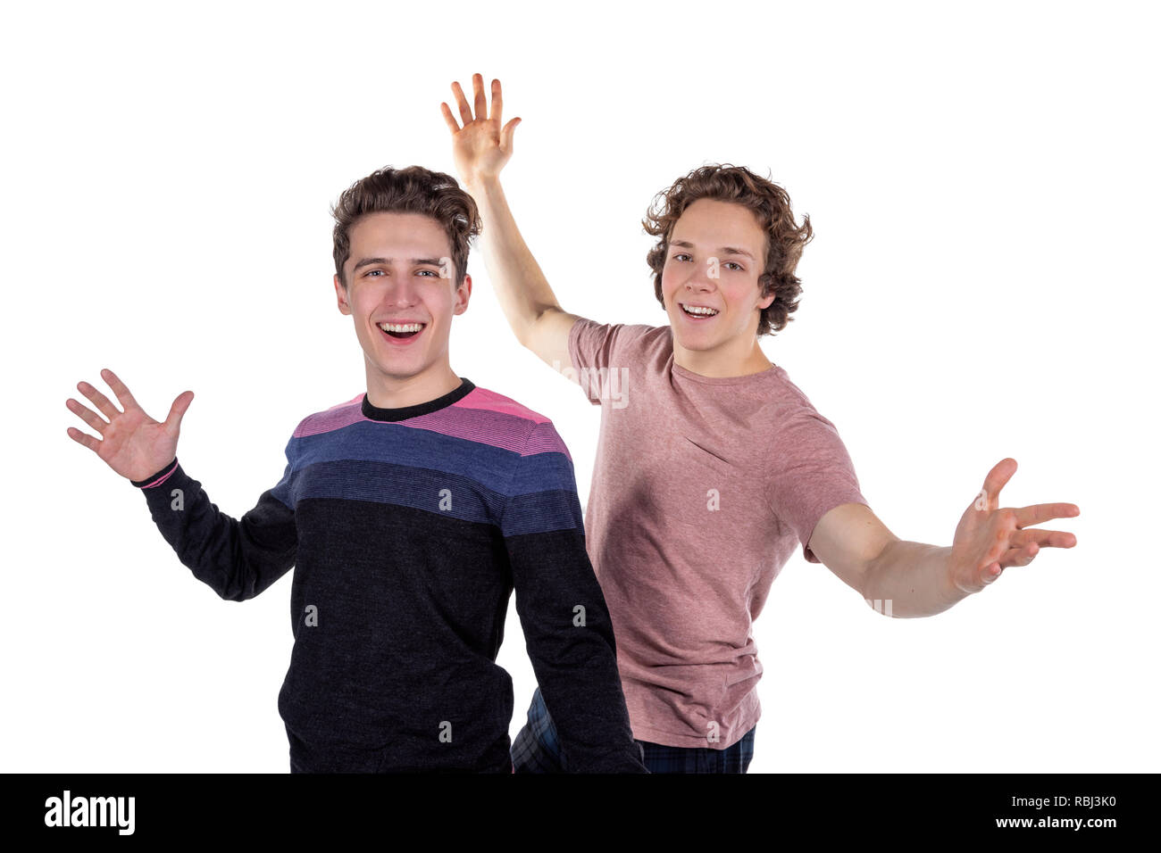 Portrait of a two cheerful young men celebrating isolated Stock Photo ...