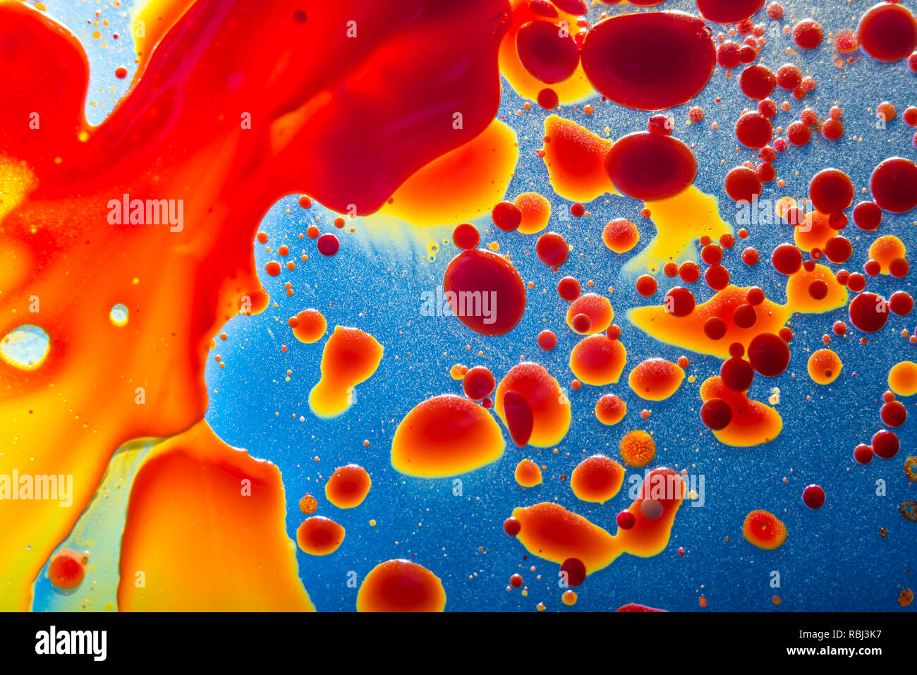 Red bubbles of blood cells on a blue background closeup. Abstraction of ...