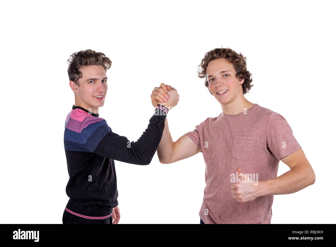 Portrait of a two cheerful young men celebrating isolated Stock Photo ...