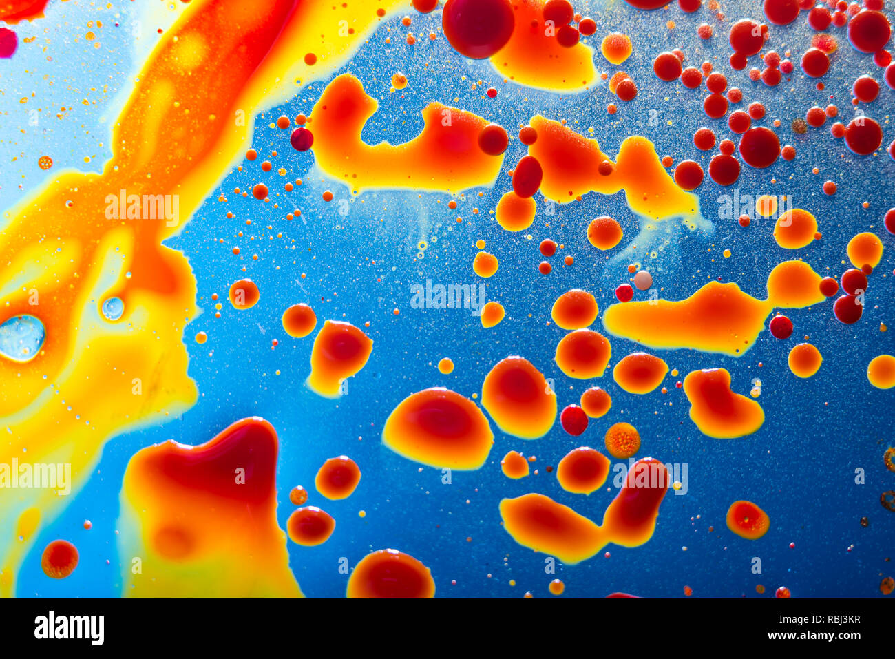 Red bubbles of blood cells on a blue background closeup. Abstraction of ...