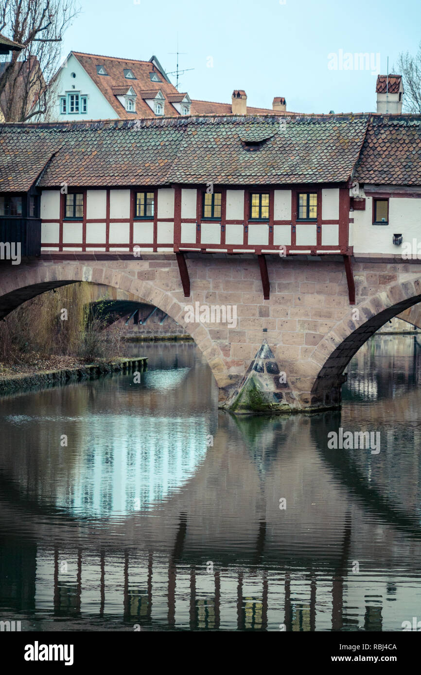 Close-up of an medieval bridge reflected in the river in the ...