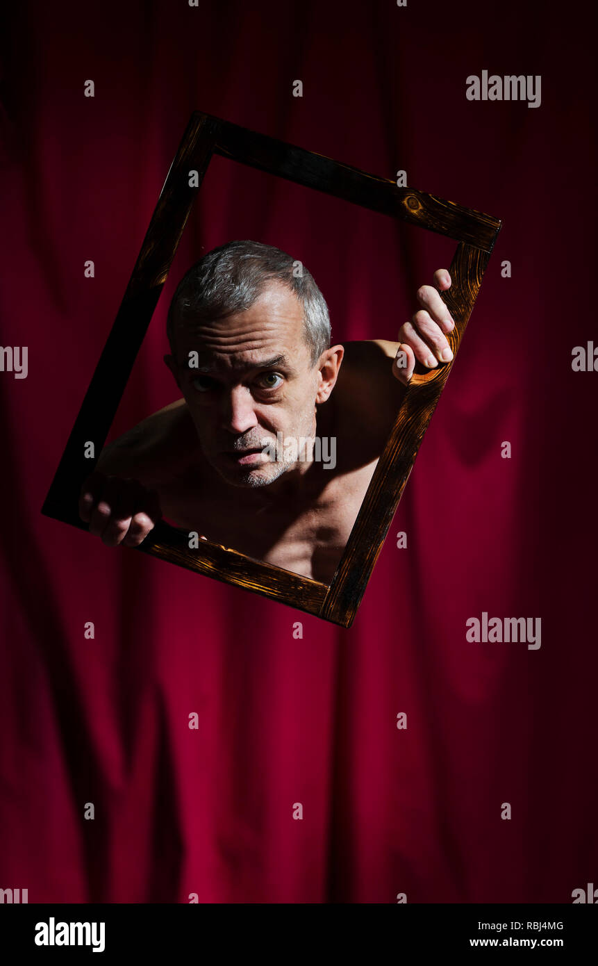 Man looking at a picture frame hi-res stock photography and images - Alamy
