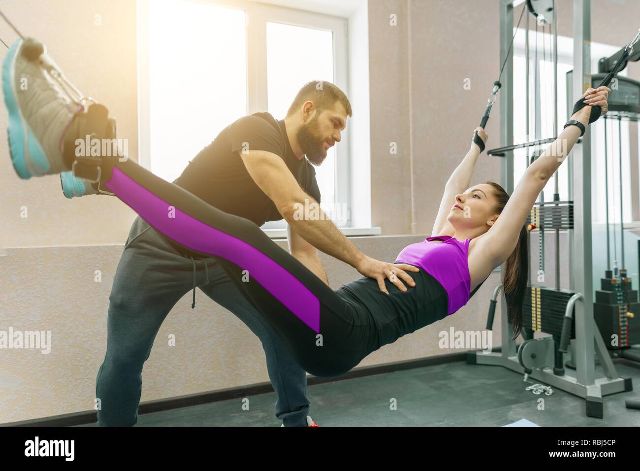 Kinesis technology, kinesitherapy, healthy lifestyle. Young woman doing ...