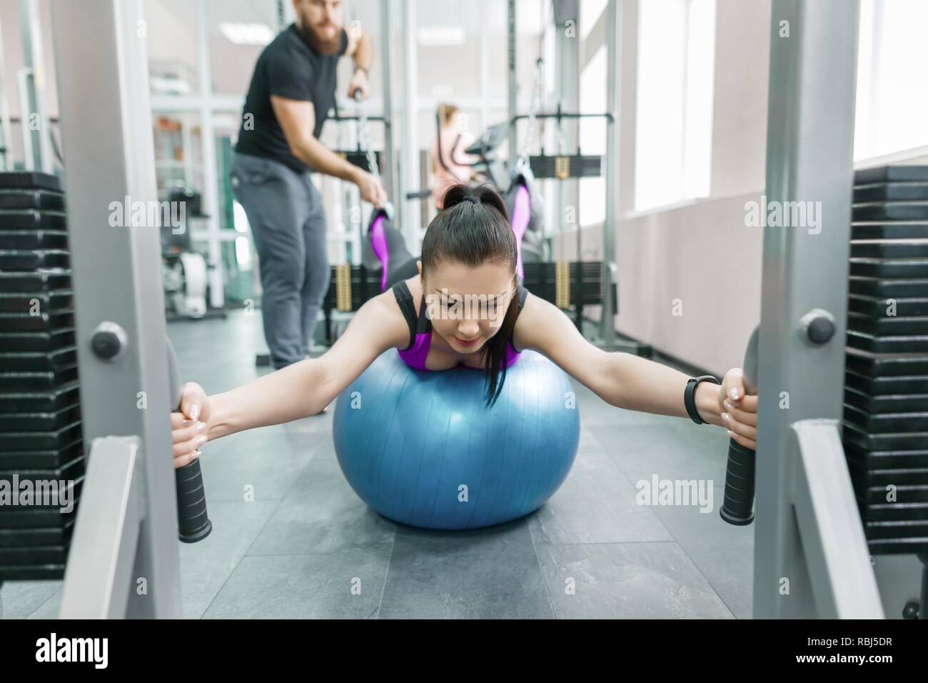 Kinesis technology, kinesitherapy, healthy lifestyle. Young woman doing ...