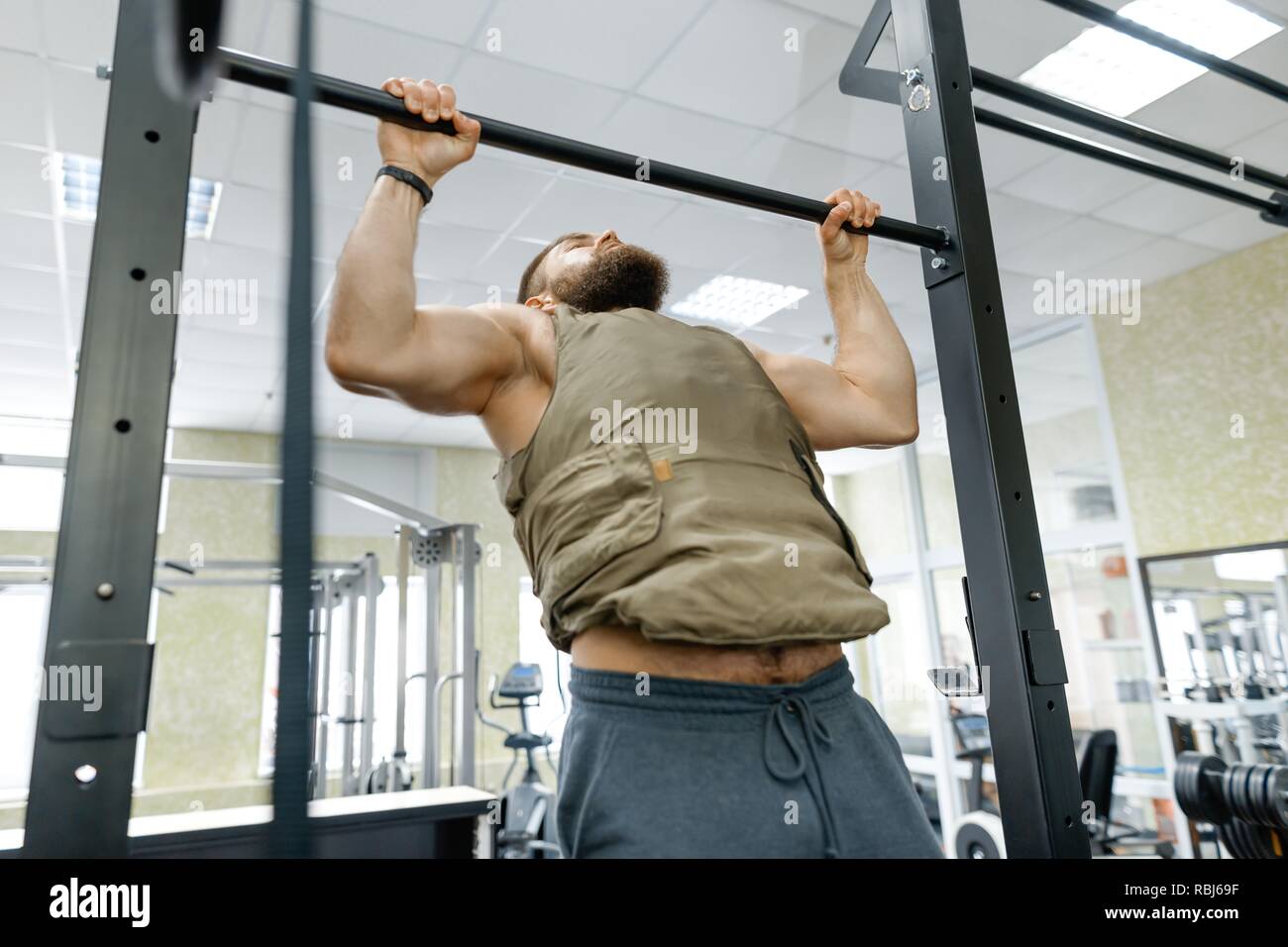Military sport, muscular caucasian bearded adult man doing exercises in ...