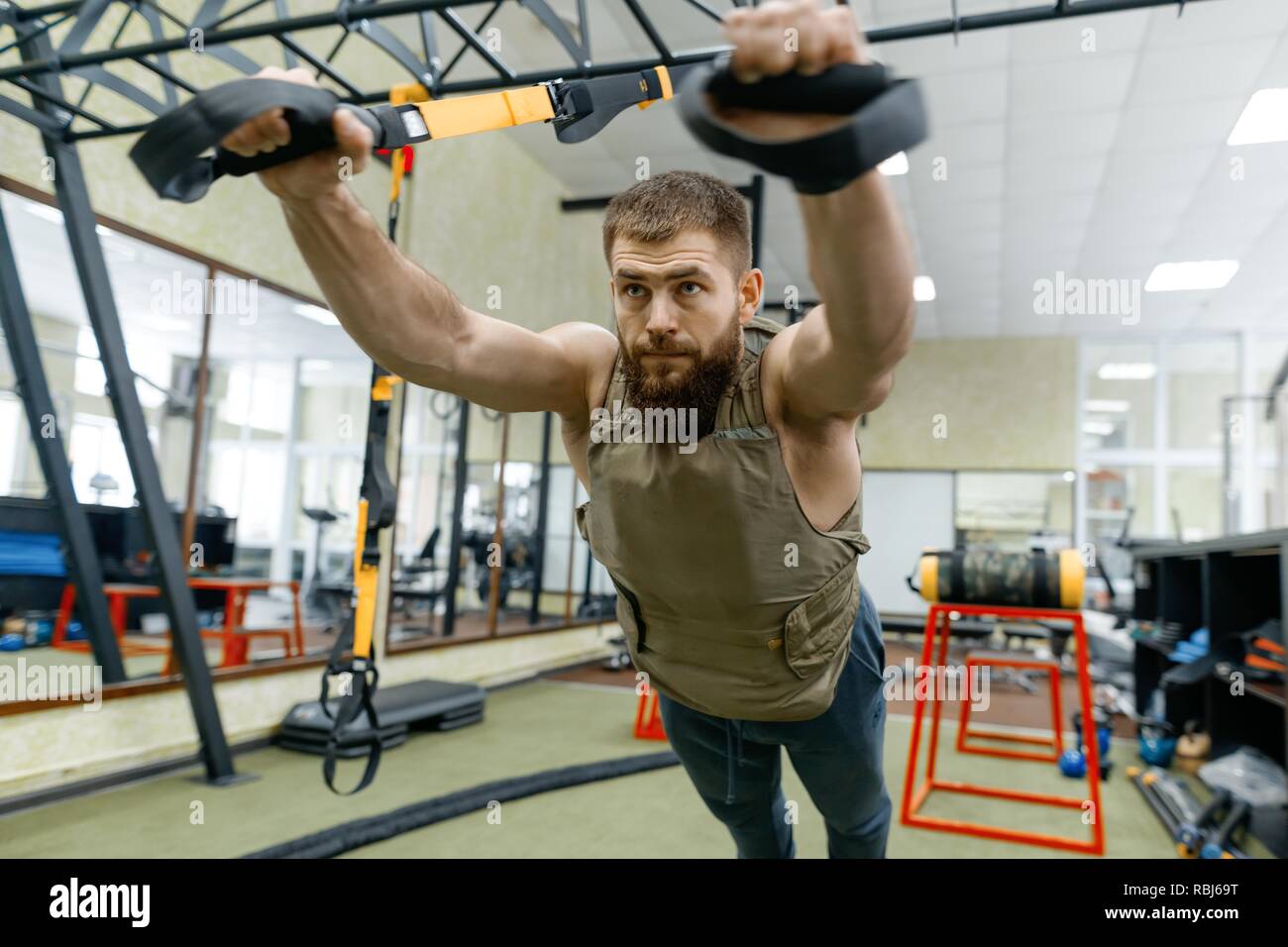 Military sport, muscular caucasian bearded adult man doing exercises in ...