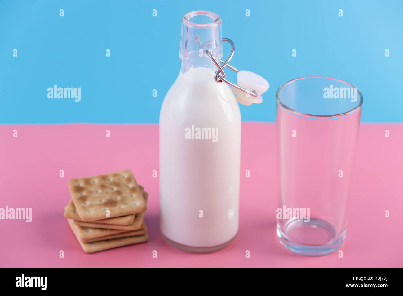 Glass bottle of fresh milk and cookies on pastel background. Colorful ...