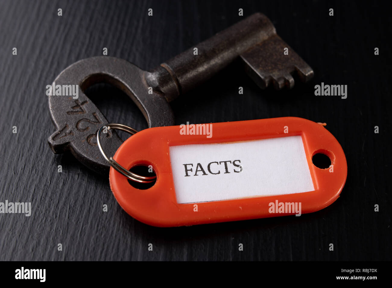 An old key with an inscription on a black table. Accessories and symbol ...