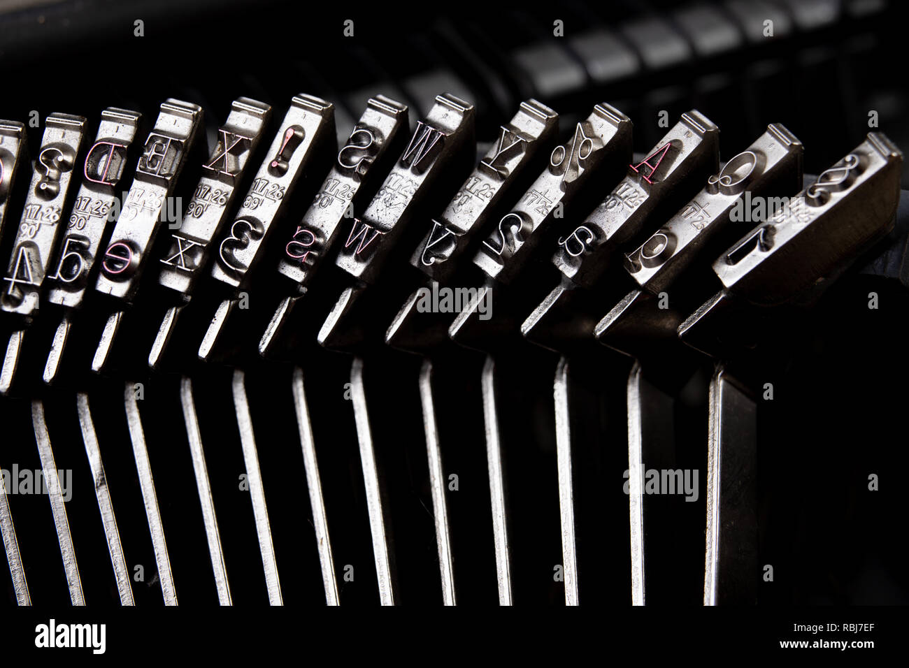Font in a typewriter. Metal stamps for imprinting letters on a white ...
