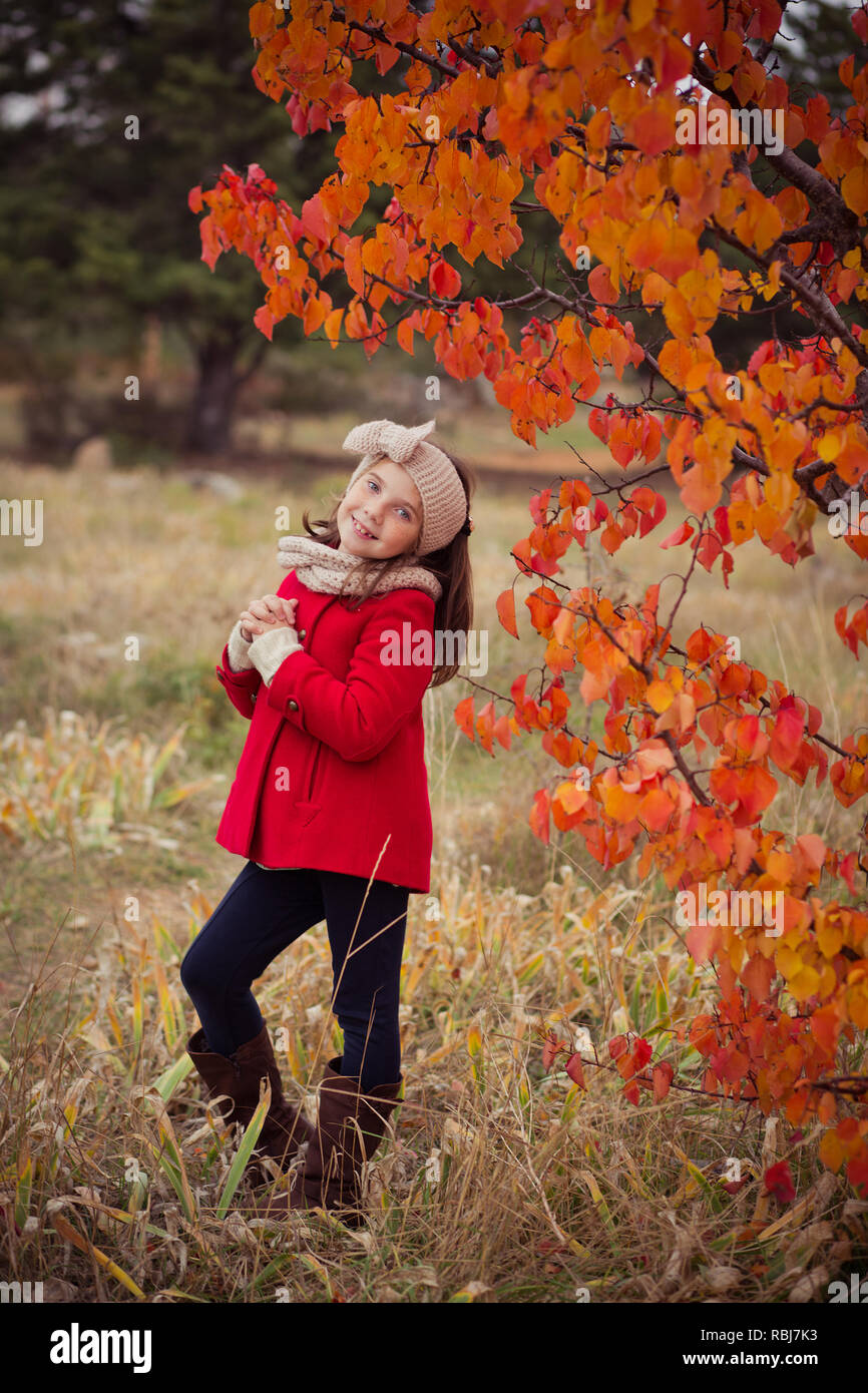 Cute young russian girl stylish dressed in warm red handmade jacket ...