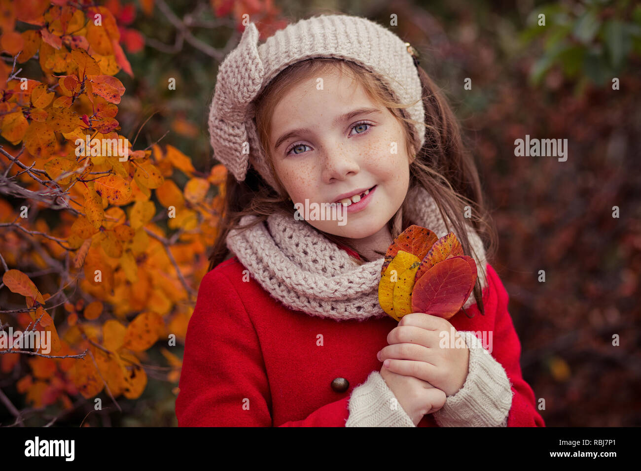 Cute young russian girl stylish dressed in warm red handmade jacket ...