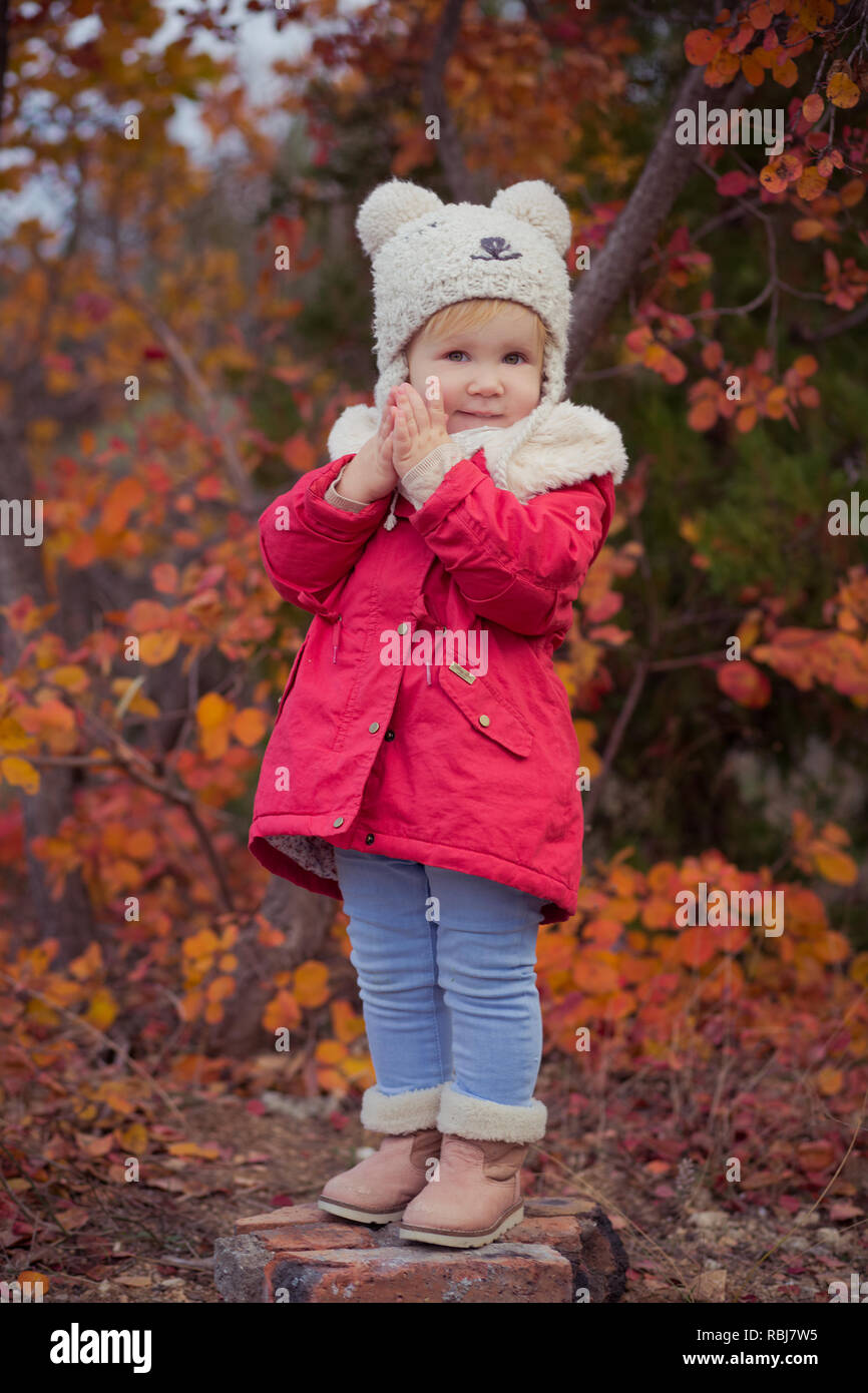 Cute young russian girl stylish dressed in warm red handmade jacket ...