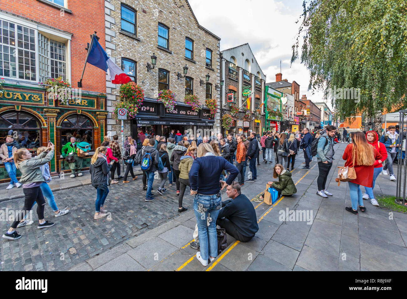 Visitors and tourists explore the Temple Bar district in Dublin ...