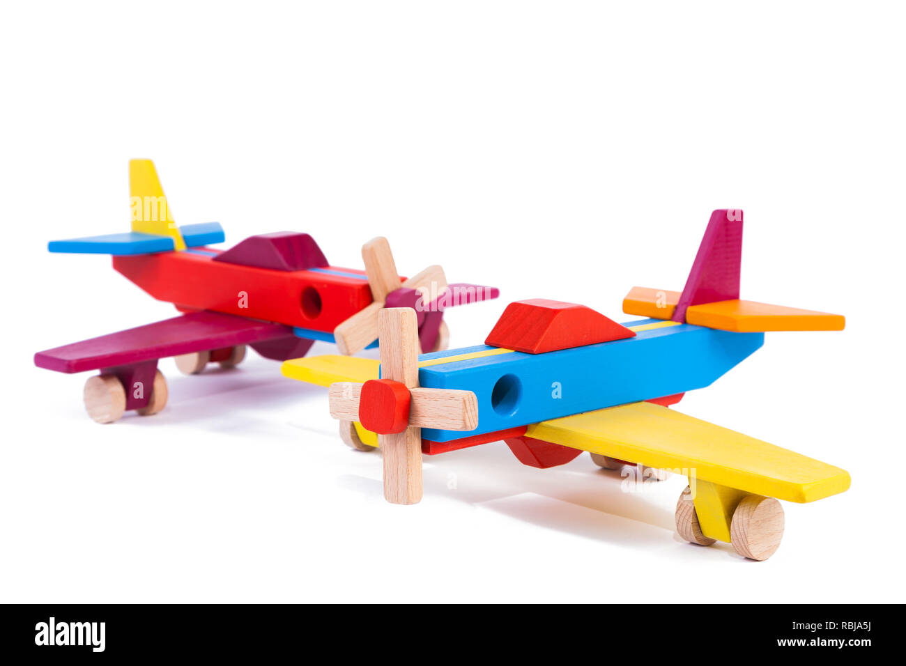 Photo of two wooden multi-colored aircraft from beech. Toy wood retro ...