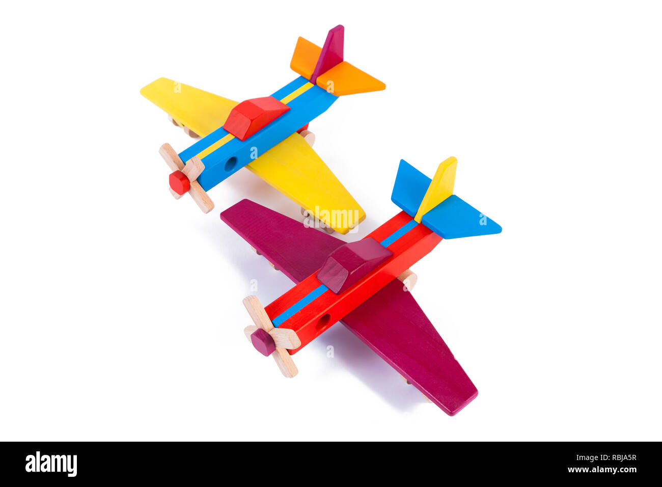 Photo of two wooden multi-colored aircraft from beech. Toy wood retro ...