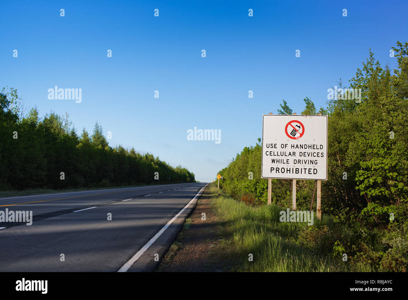Highway sign prohibiting use of handheld cellular devices while driving ...