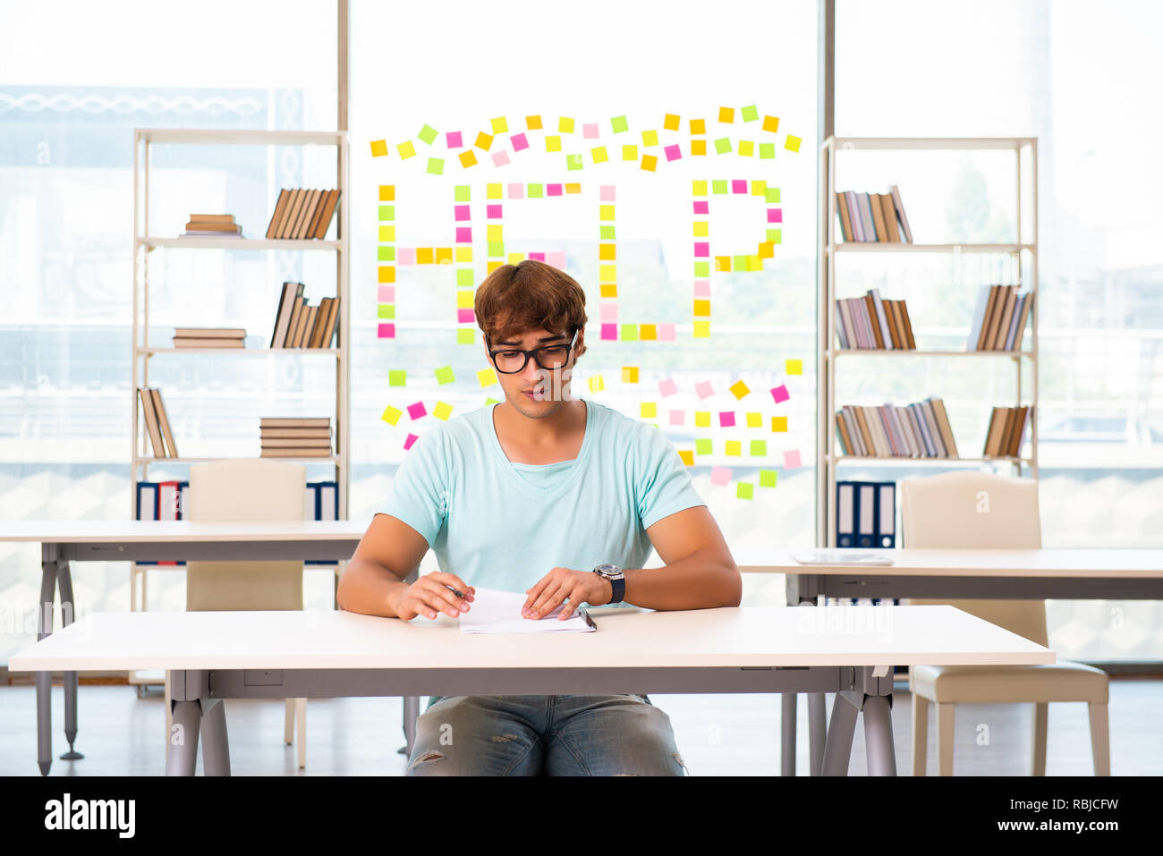 Student struggling at the exam in classroom Stock Photo - Alamy