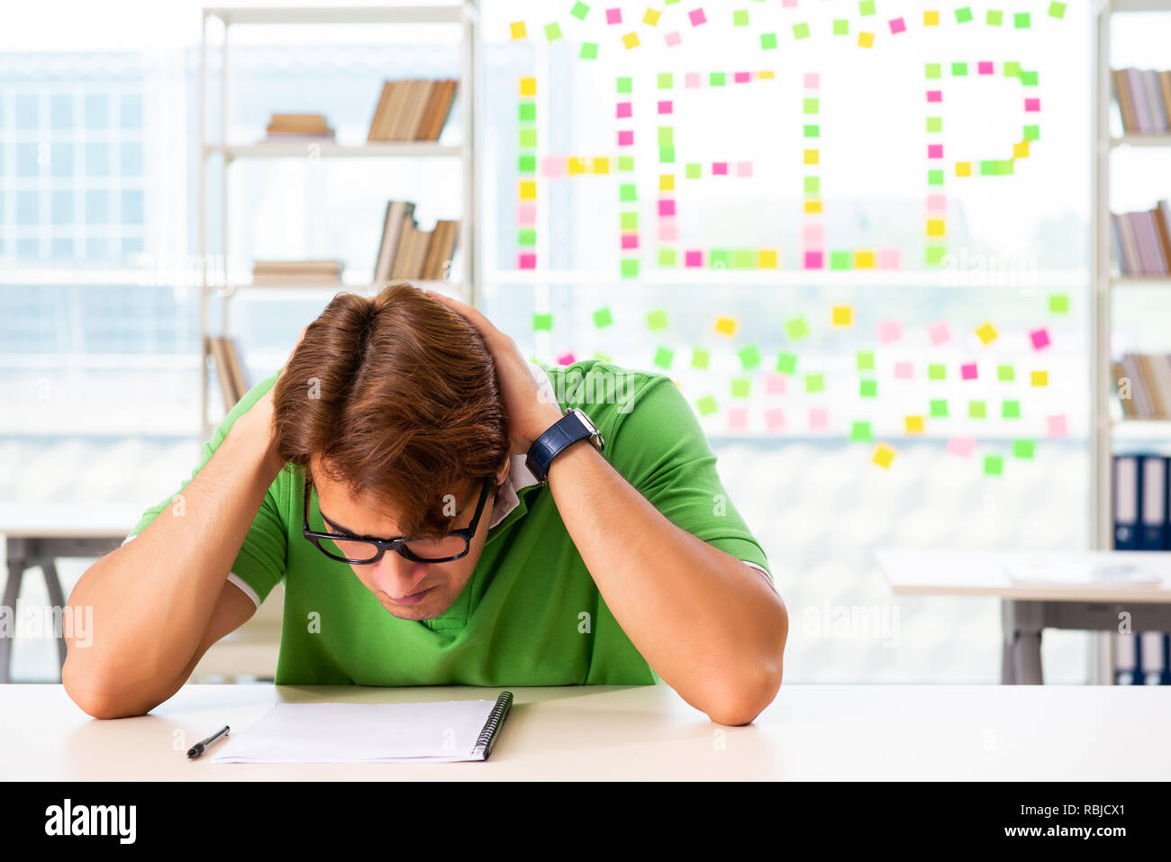 Student struggling at the exam in classroom Stock Photo - Alamy