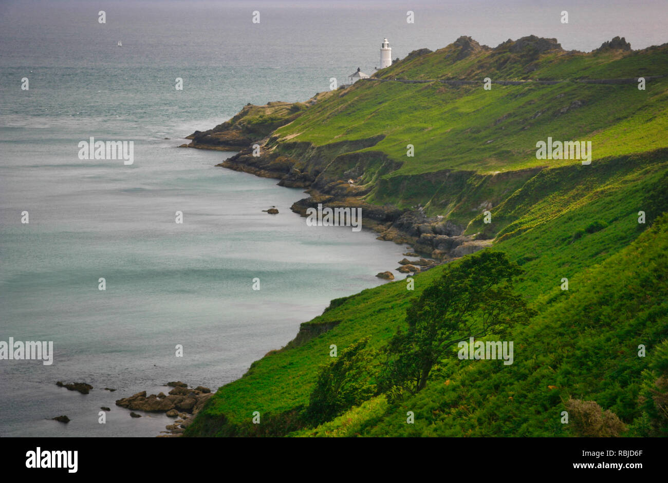 The lighthouse of Start Point at the seaside with cliffs, Devon ...