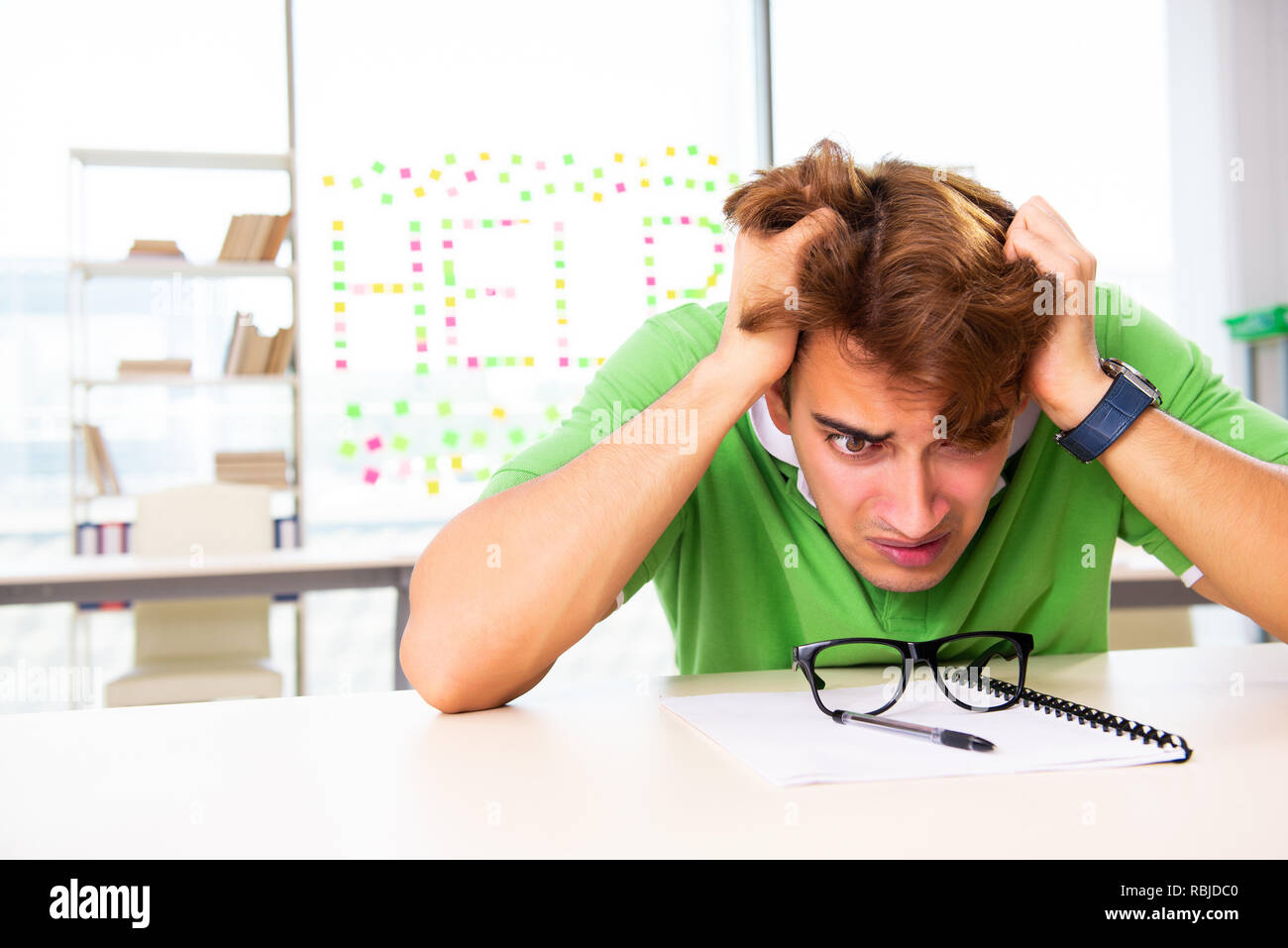 Student struggling at the exam in classroom Stock Photo - Alamy