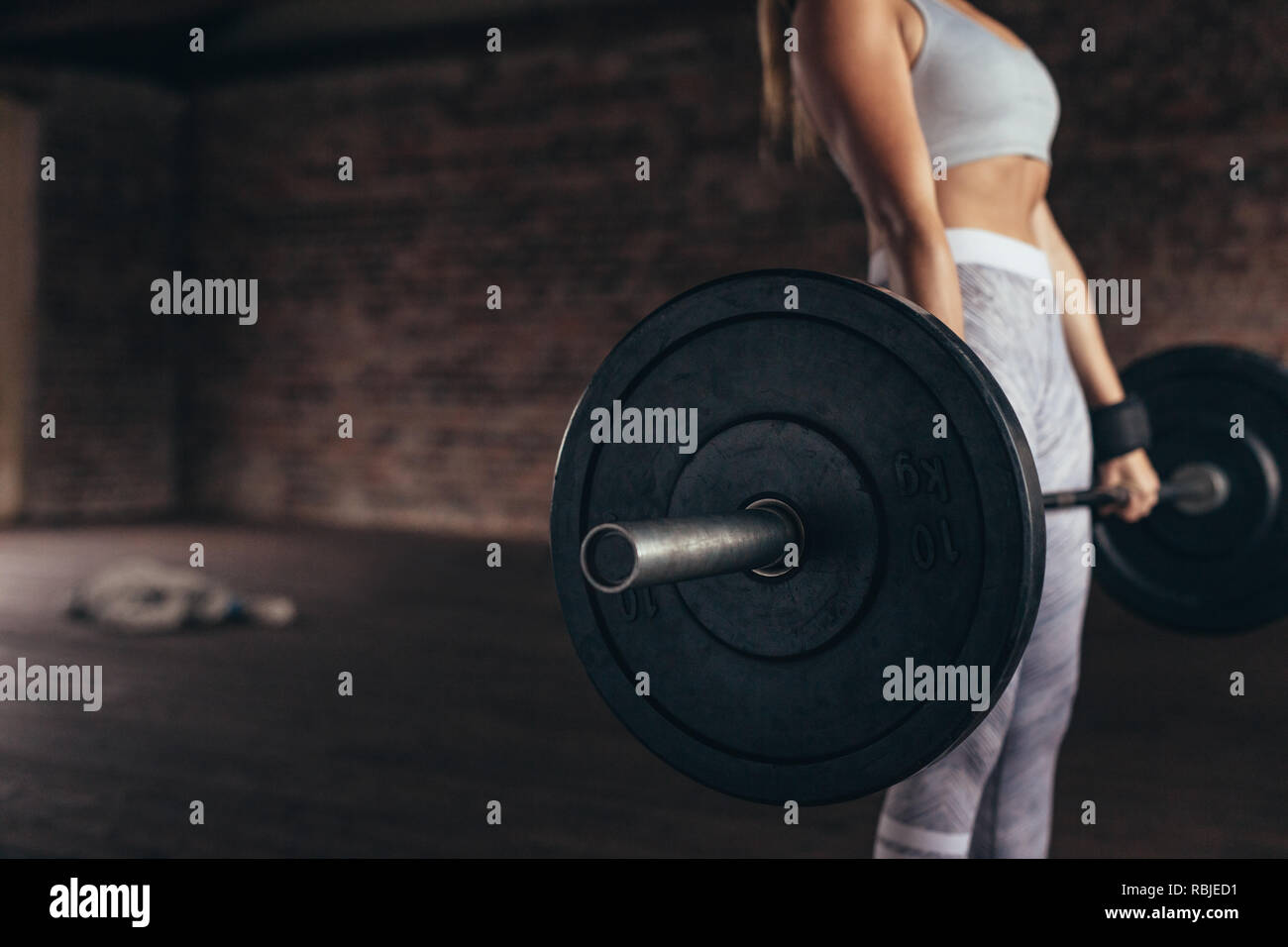 fitness female exercising with heavy weight barbell in health club ...