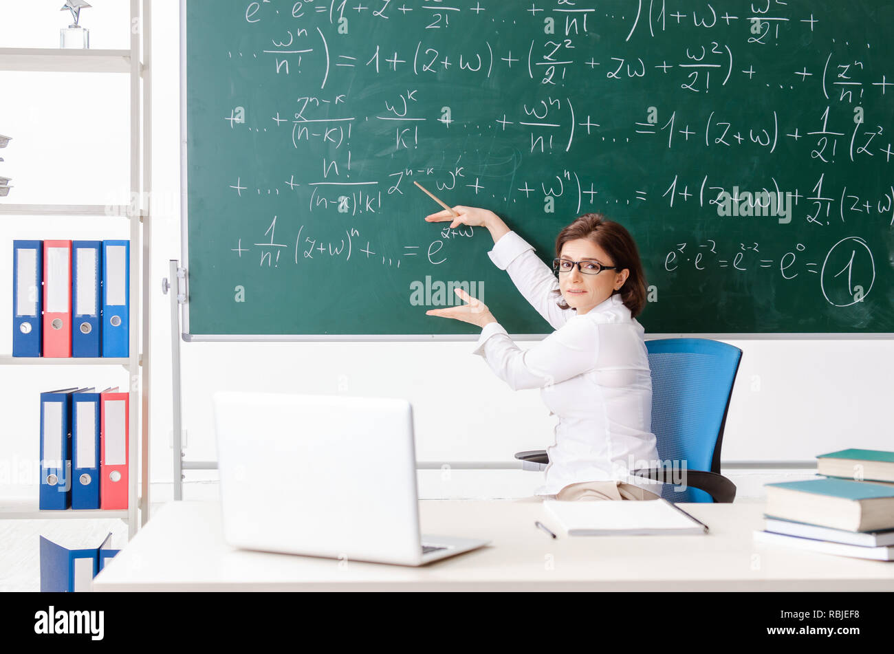 Female math teacher in front of the chalkboard Stock Photo - Alamy
