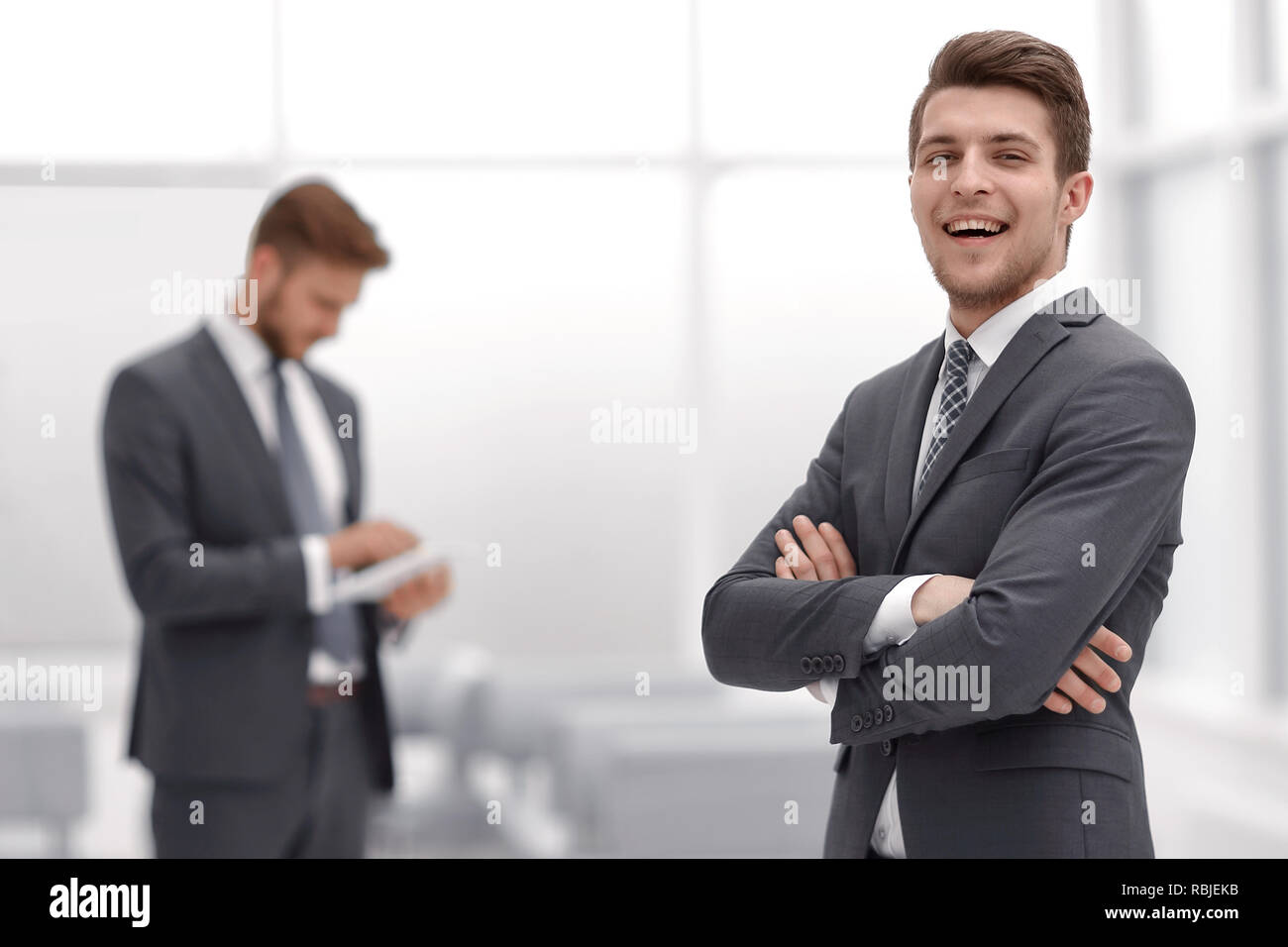 successful businessman on the background of the office Stock Photo - Alamy