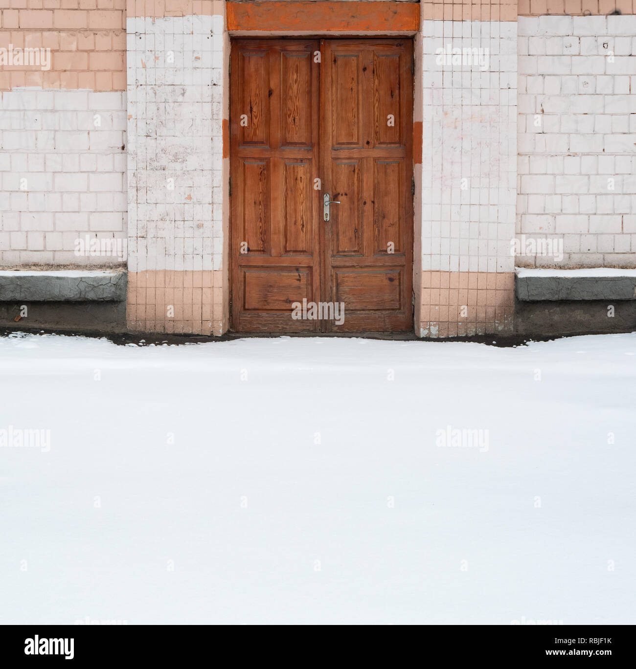 wooden door entrance to the residential building with untouched white ...