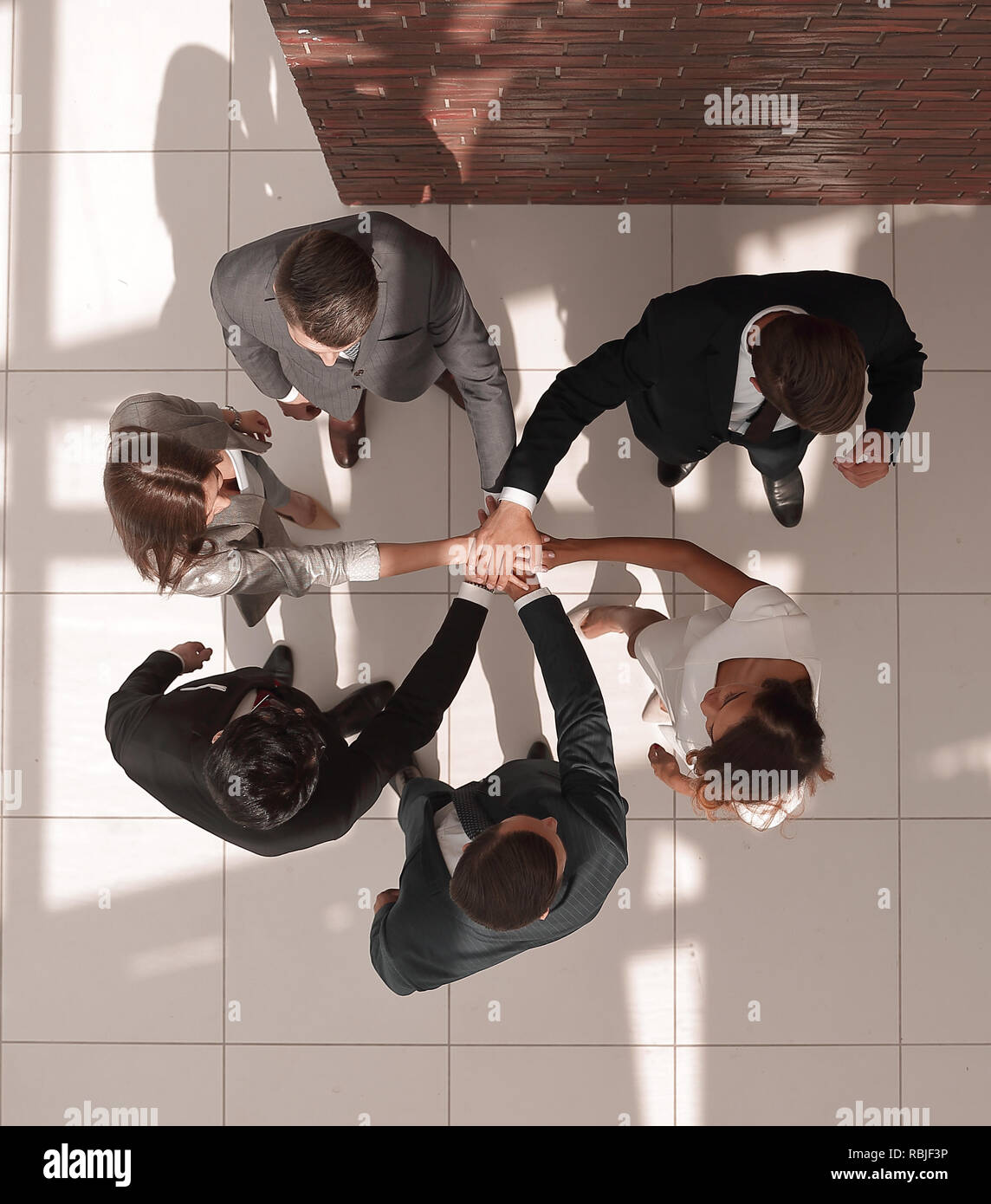 top view. a group of business people with their hands folded together ...