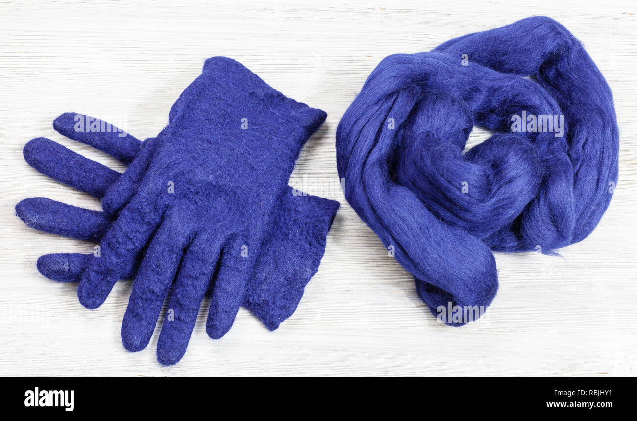 workshop of hand making a fleece gloves from blue Merino sheep wool ...