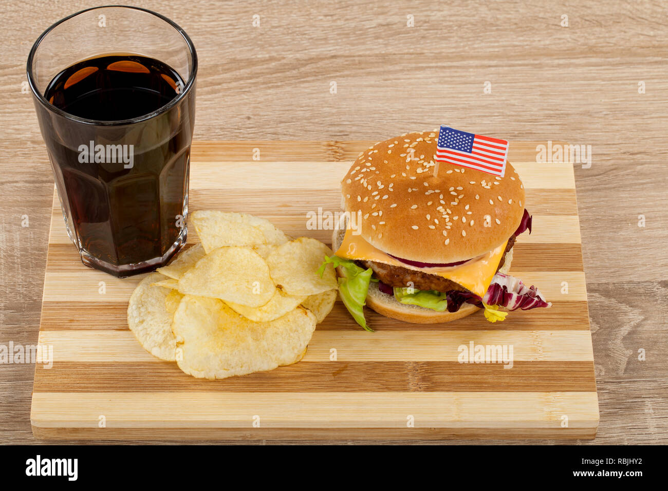Delicious cheeseburger with beef, cheddar and lettuce, a side of potato ...