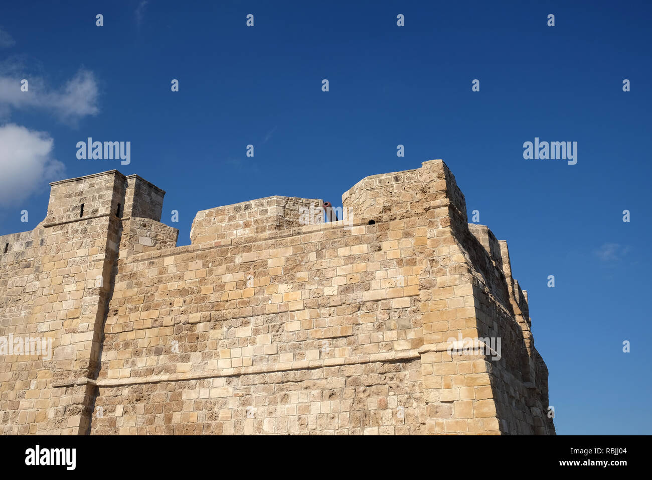 Top section of antique castle wall from old sandy limestone and the ...