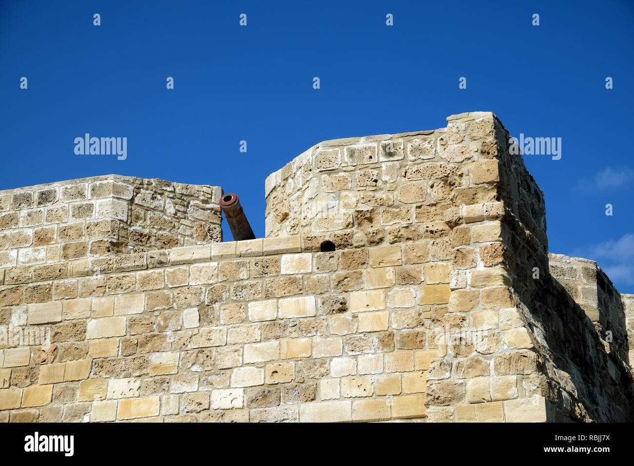 Top section of antique castle wall from old sandy limestone and the ...