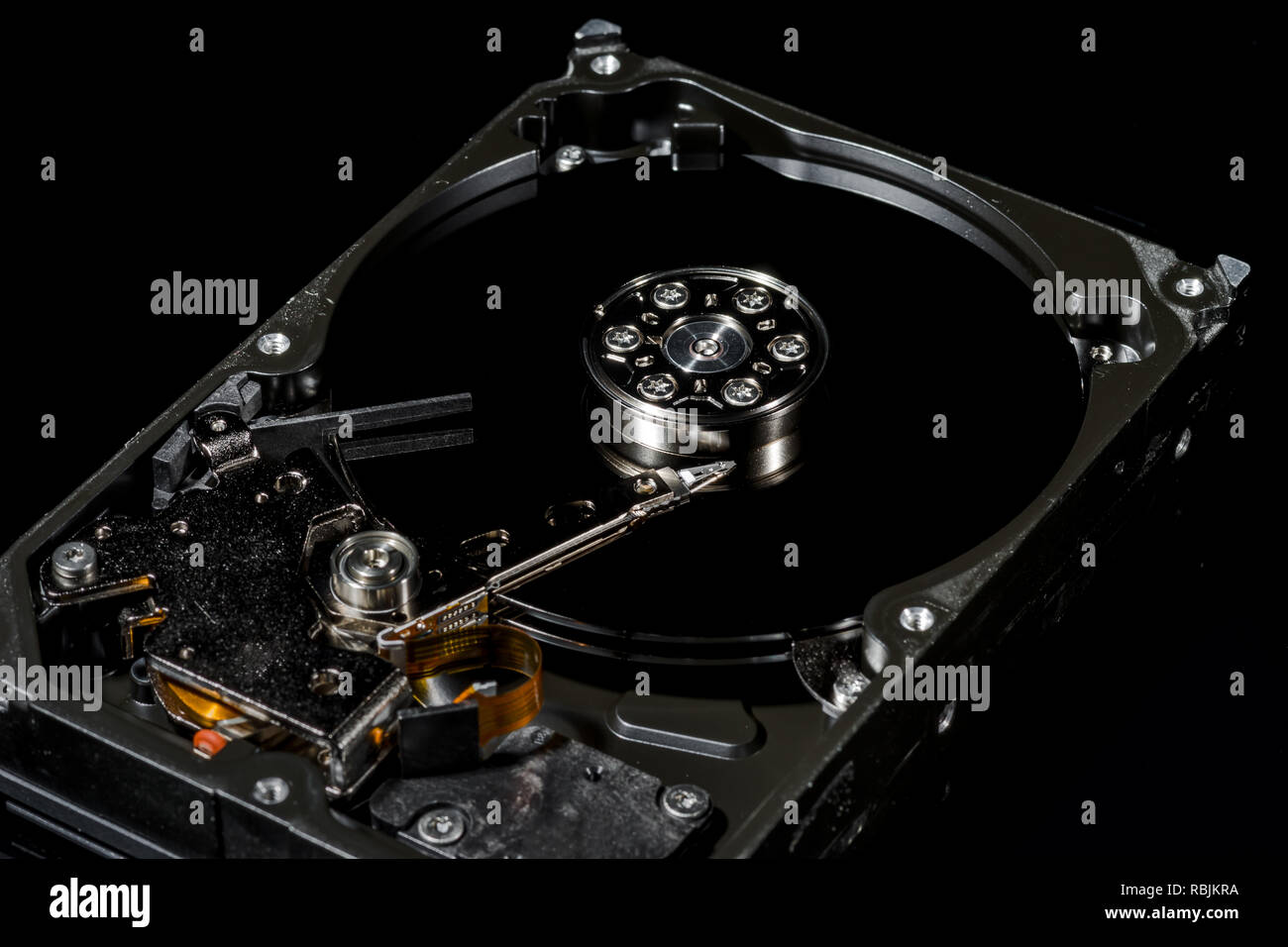 Disassembled and opened hard disk drive, inside view with reflections ...
