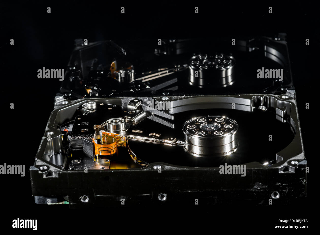 Disassembled and opened hard disk drive, inside view with reflections ...