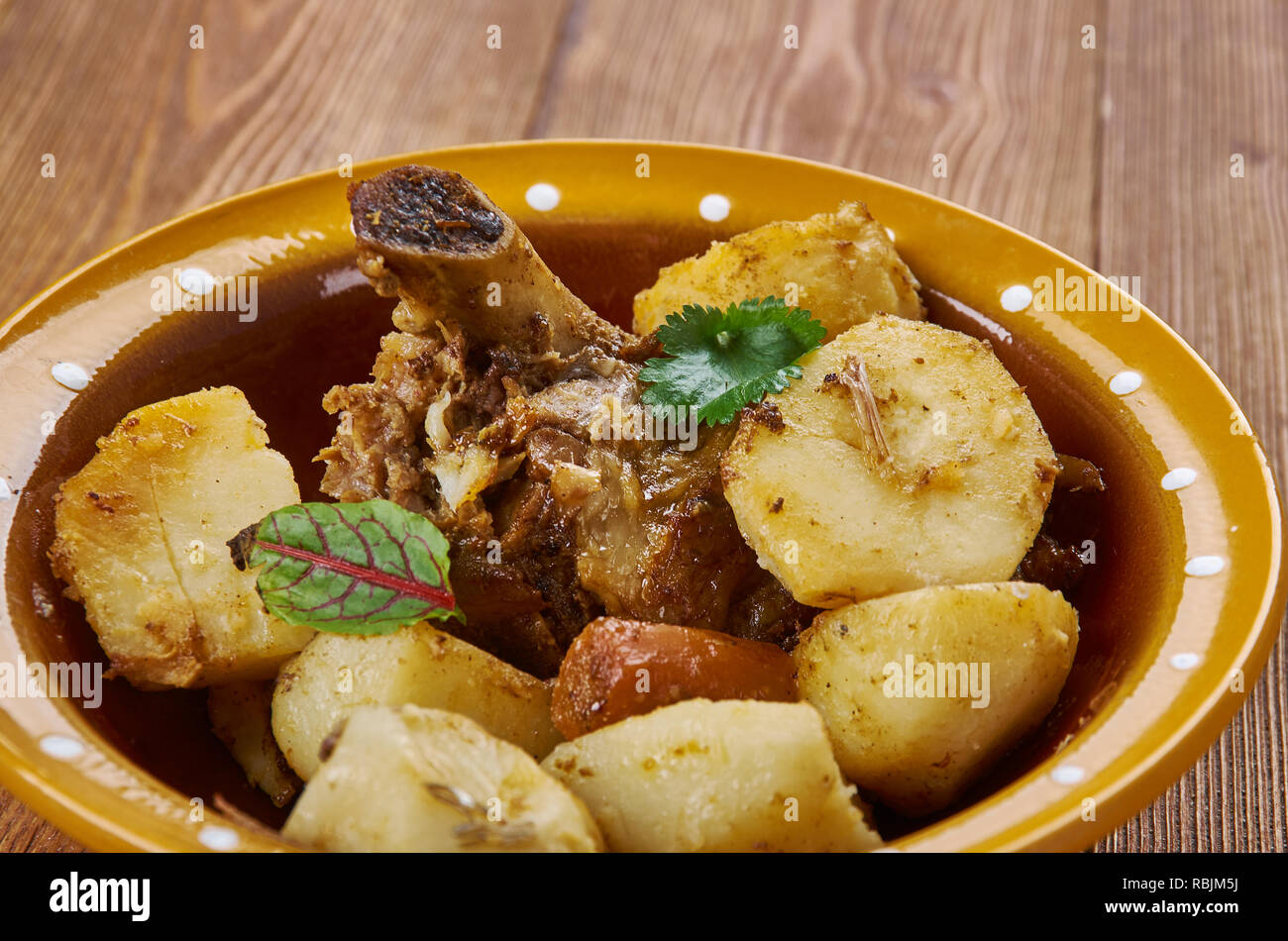Greek lamb kleftiko with potatoes, oregano and lemon Stock Photo - Alamy