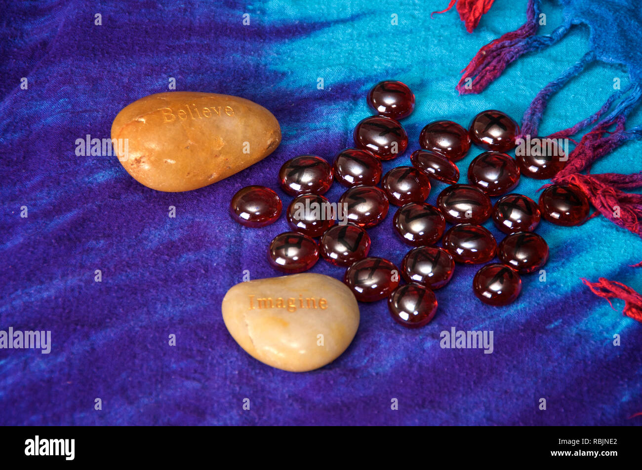 Two large rocks with the words Believe and Imagine on blue cloth ...