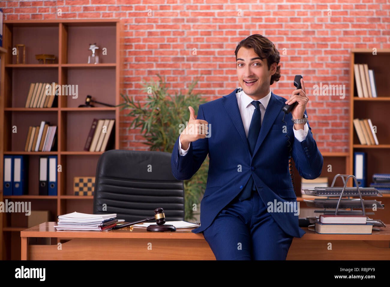 Young handsome lawyer working in his office Stock Photo - Alamy