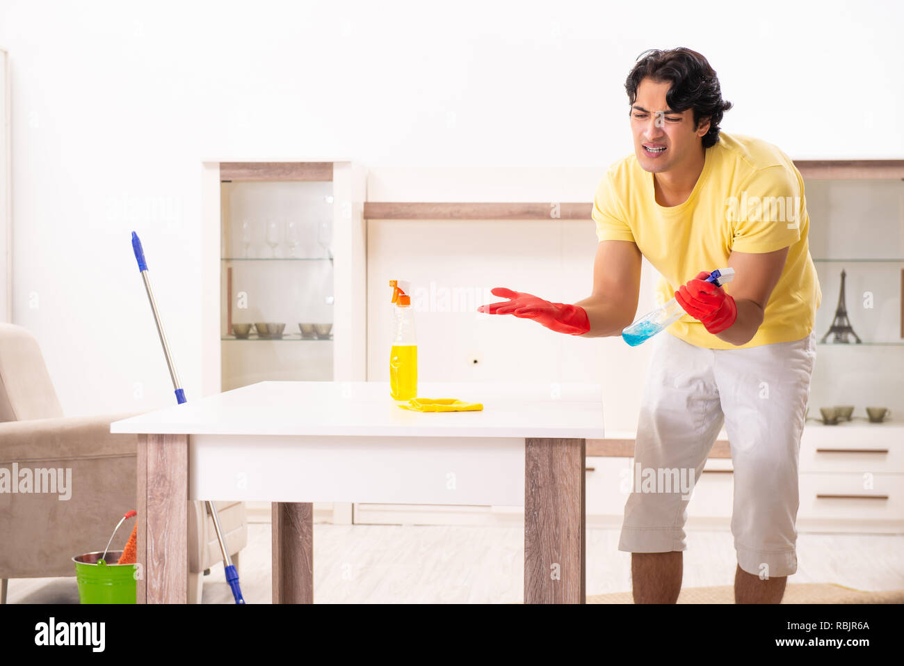 Young handsome man doing housework Stock Photo - Alamy