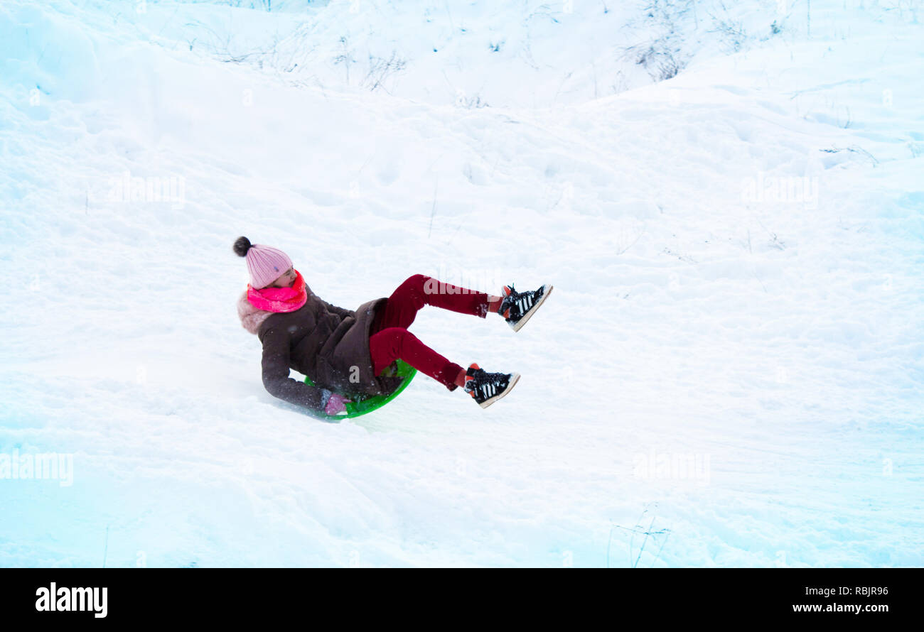 girl flies on a slide from an ice slide Stock Photo - Alamy
