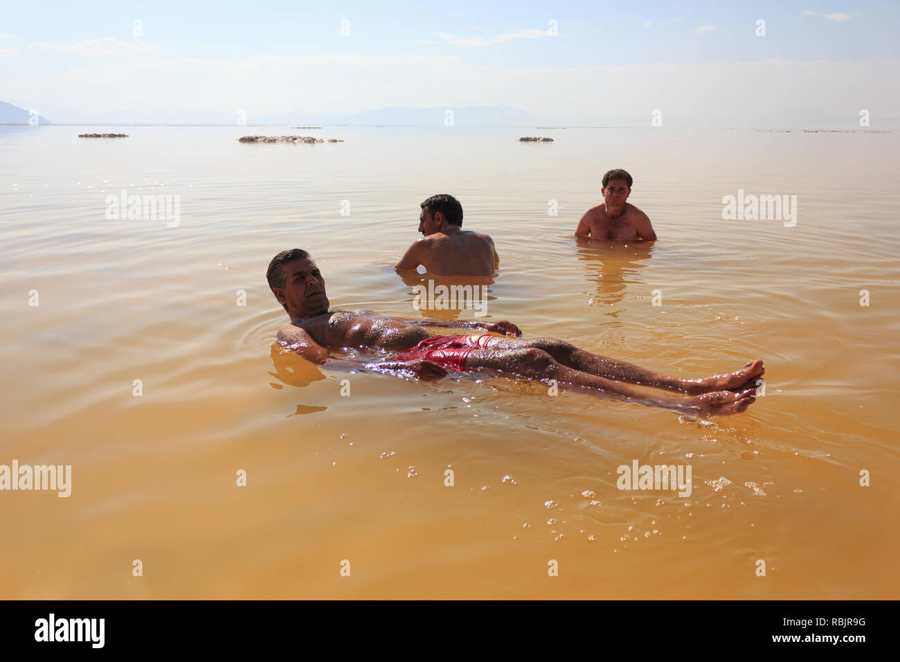 People are swimming in the salt Urmia Lake, West Azerbaijan province ...