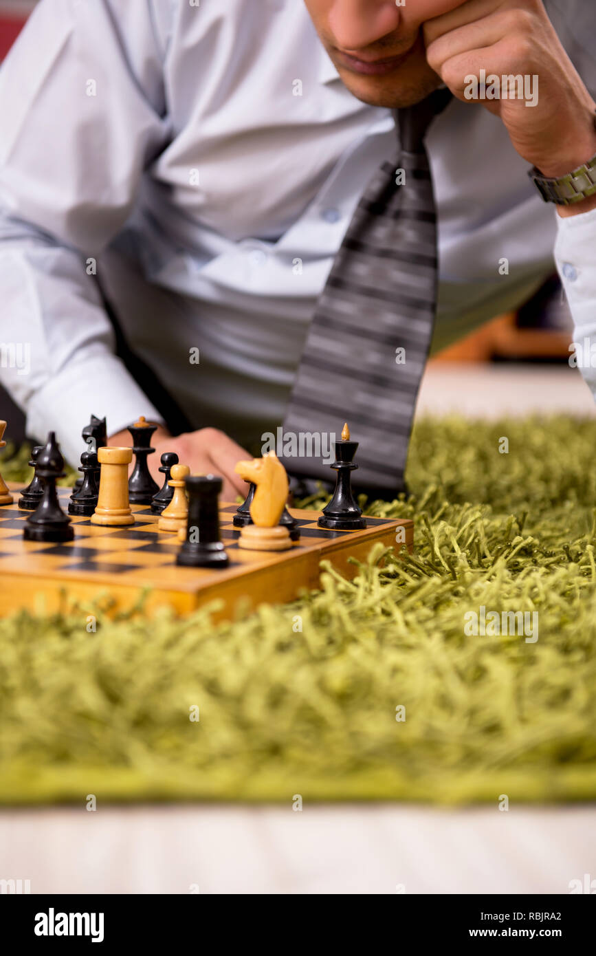 Young handsome boss playing chess during break Stock Photo - Alamy