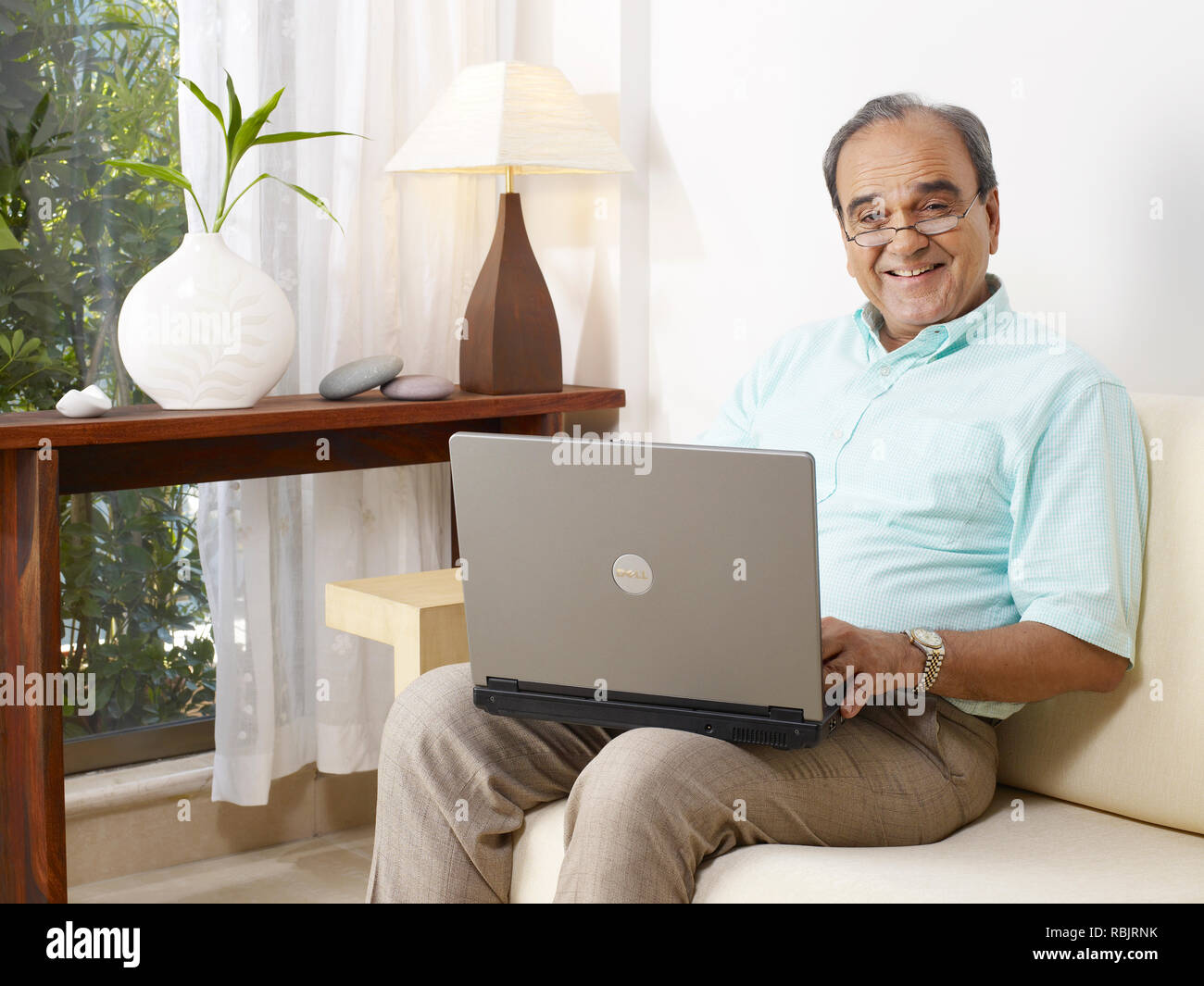 OLD MAN WORKING ON A LAPTOP IN HIS HOME Stock Photo - Alamy