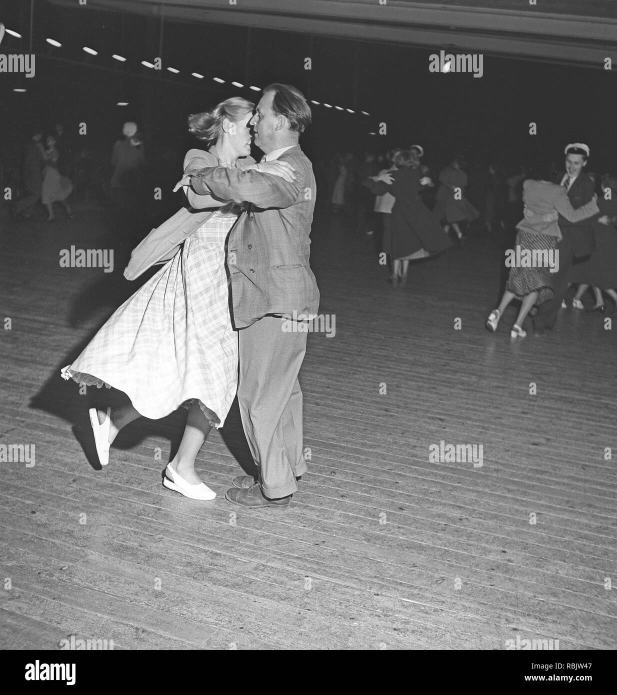 Dancing in the 1940s. A young couple at a dance event is whirling ...