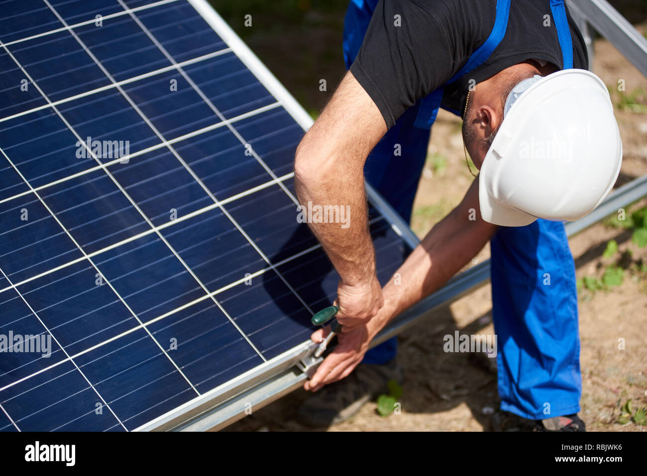 Close-up of technician working on exterior voltaic stand-alone solar ...