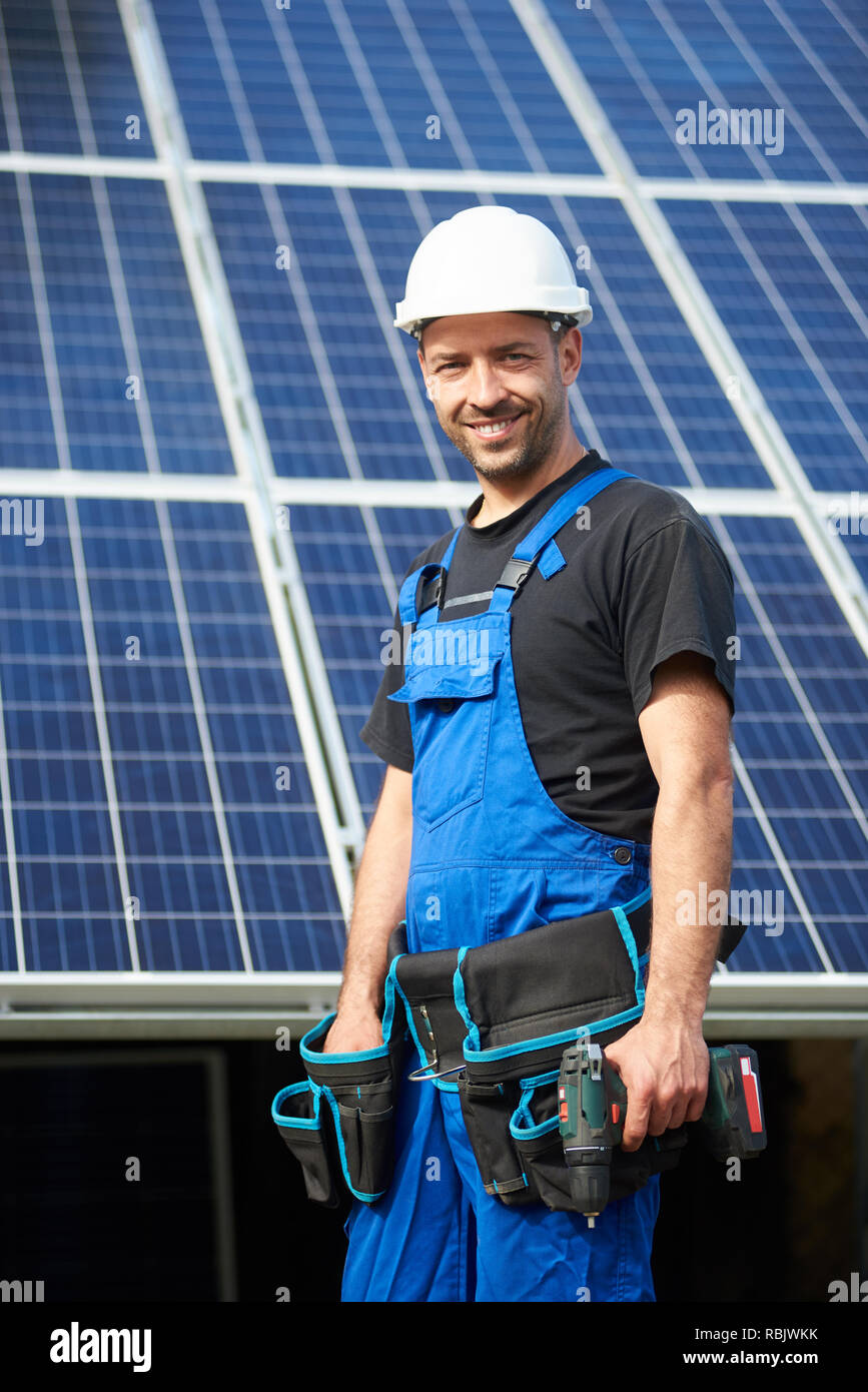 Confident construction worker in green overalls hi-res stock ...
