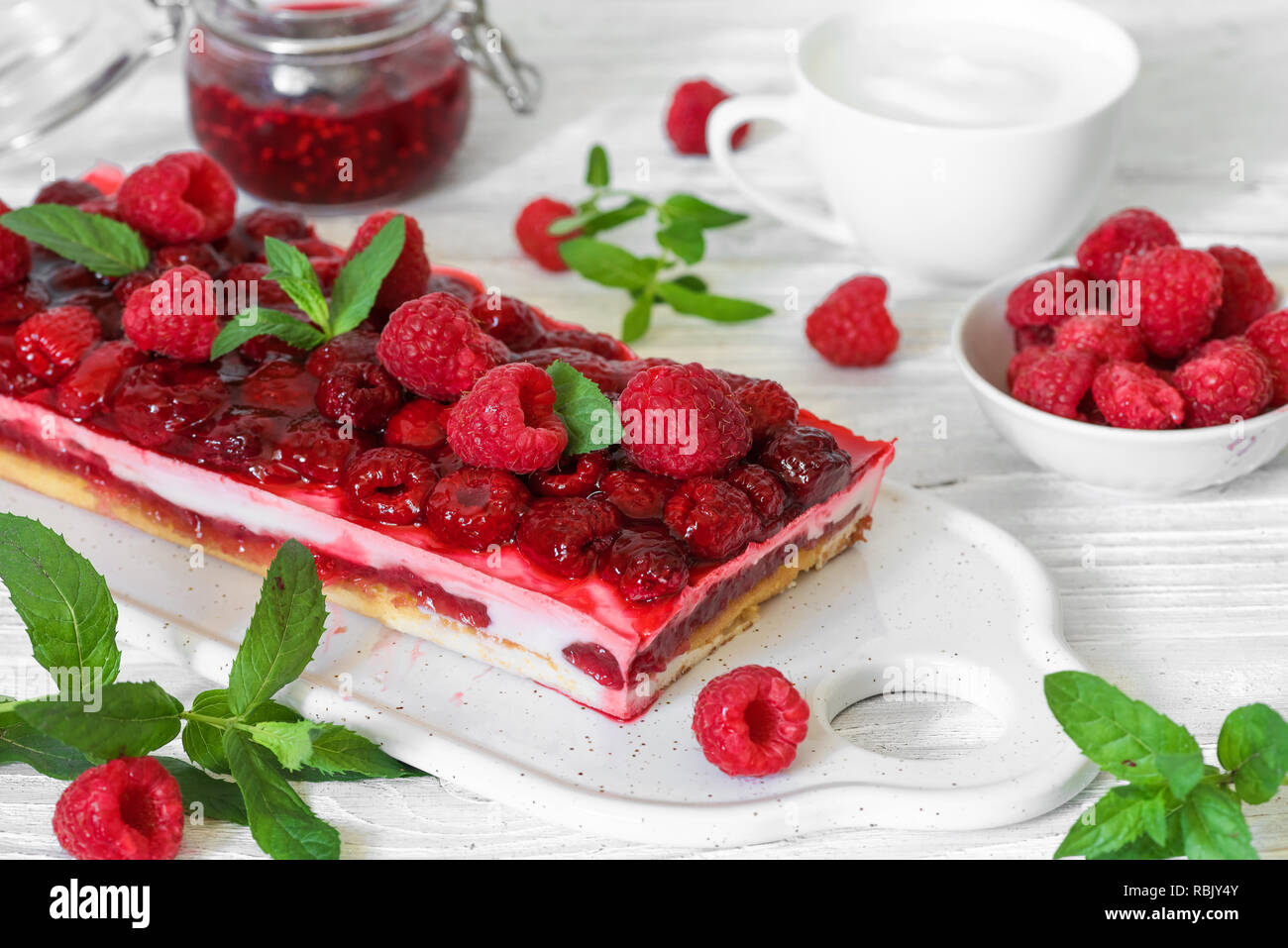 raspberry creamy cake or cheesecake with freash berries, mint, jam and ...