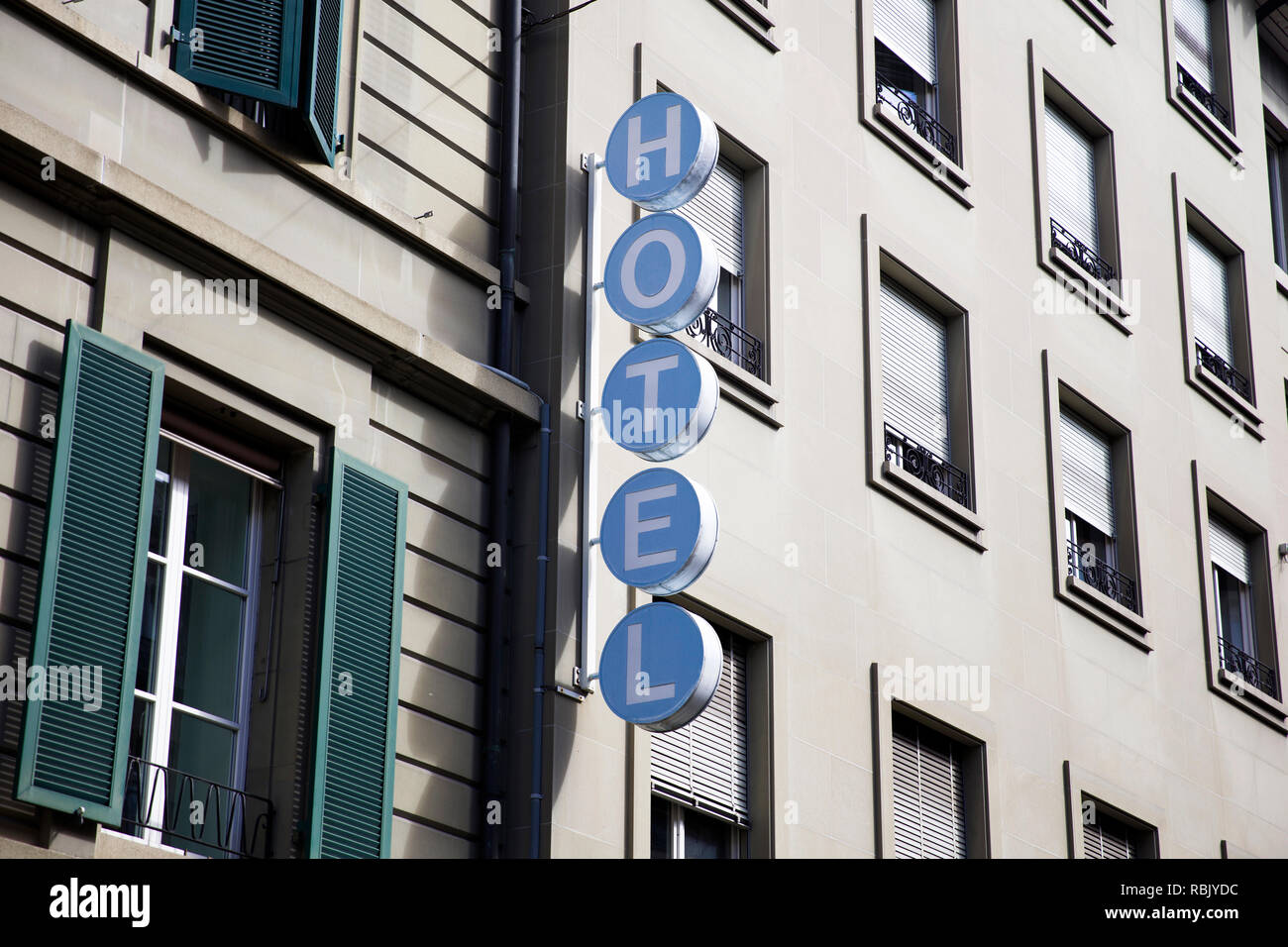 Blue round hotel sign on the building Stock Photo - Alamy