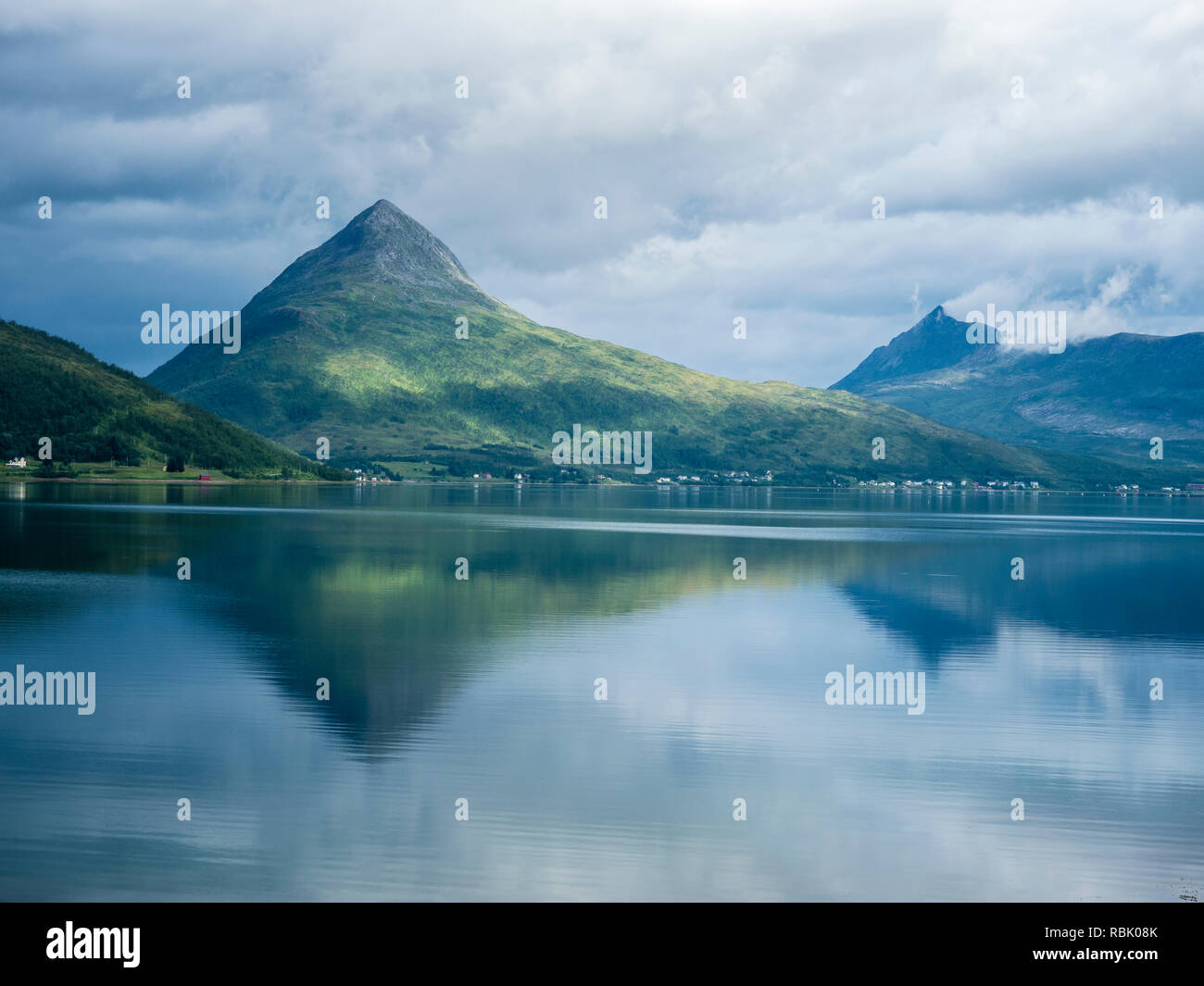 Senja, view from Fjordbotn campsite over calm lake to mountain range ...